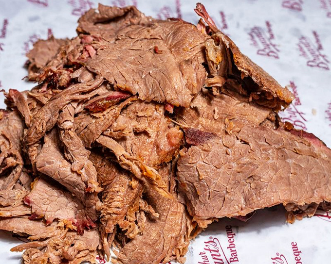 Behold the brisket in all its glory&mdash;tender slices bearing that coveted pink smoke ring that whispers, "Yes, this was done right."