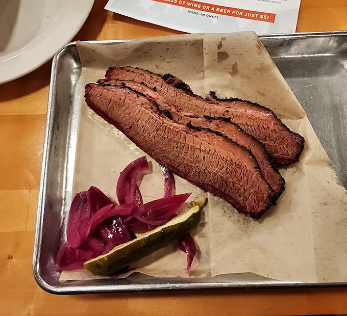 Behold the brisket in all its glory – those pink smoke rings aren't just for show, they're barbecue badges of honor earned through patience.