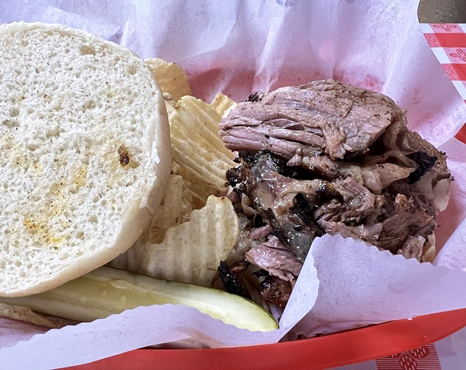 Behold the star of the show: tender brisket nestled alongside chips and a bun, ready to transport you to smoky nirvana with each bite.