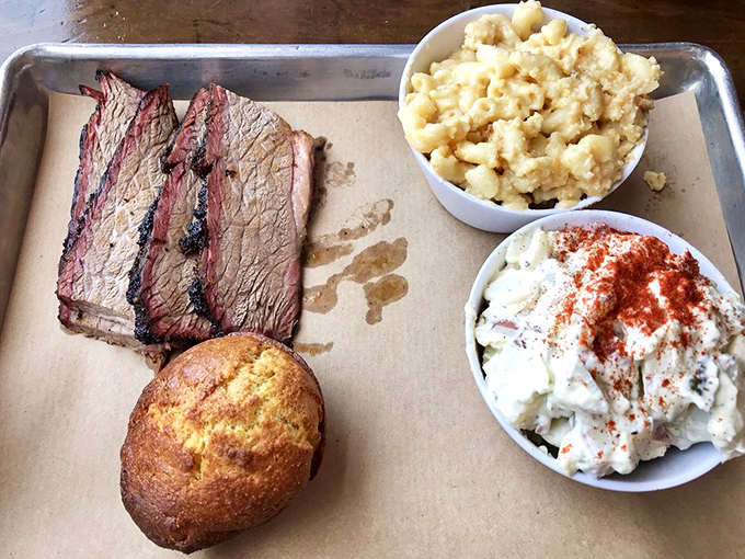 Brisket so perfectly smoked it practically poses for its portrait, flanked by mac and cheese and potato salad.