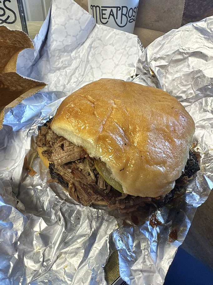 This isn't just a sandwich; it's a monument to slow-smoked perfection. The bun is merely a delivery system for meat nirvana.