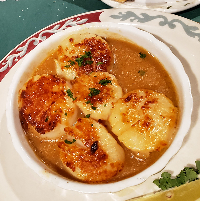 These broiled scallops aren't just swimming in butter sauce&mdash;they're doing the backstroke in flavor heaven, waving at you to join them.