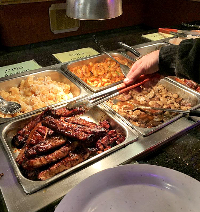 Glistening barbecue ribs neighbor golden-fried treasures in this buffet tableau—a delicious dilemma where the only wrong choice is not trying everything.
