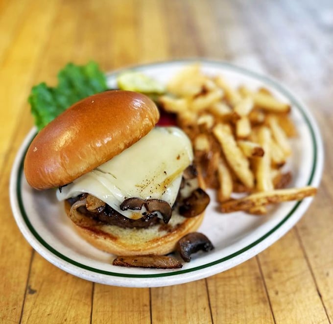 The mushroom Swiss burger arrives like a delicious architectural achievement – perfectly stacked, cheese melting just so, with fries that demand to be savored one by one.