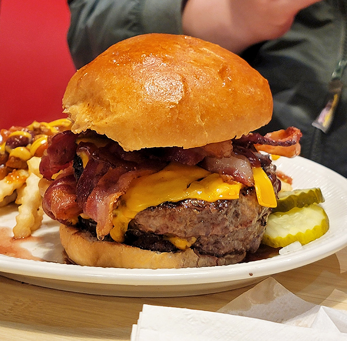 This burger arrives looking like it graduated summa cum laude from Patty University with honors in bacon.