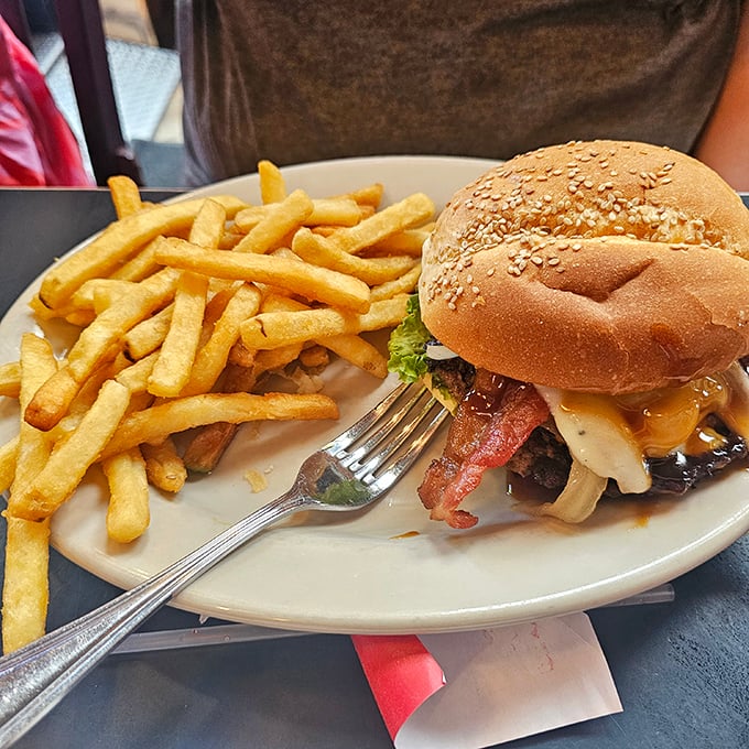 This isn't just a burger&mdash;it's edible architecture. Notice how the melty cheese cascades perfectly over that sesame-speckled bun.