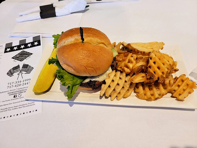This isn't just a burger; it's edible architecture &ndash; a perfectly stacked masterpiece with waffle fries that deserve their own monument on the battlefield.