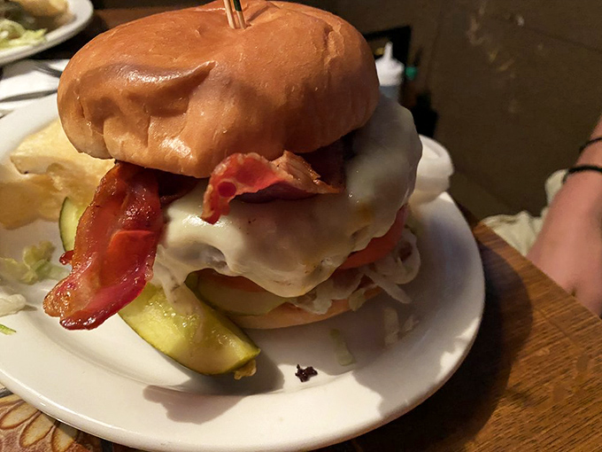 Architecture in burger form&mdash;layers of bacon, cheese, and beef creating a skyscraper that requires both hands, several napkins, and zero shame.