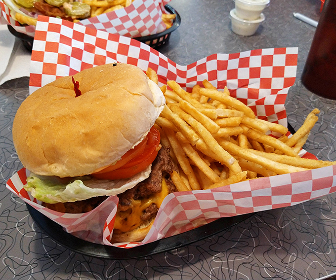This isn't just a burger &ndash; it's edible nostalgia served with golden fries in a red checkered basket that practically screams "comfort food masterpiece."