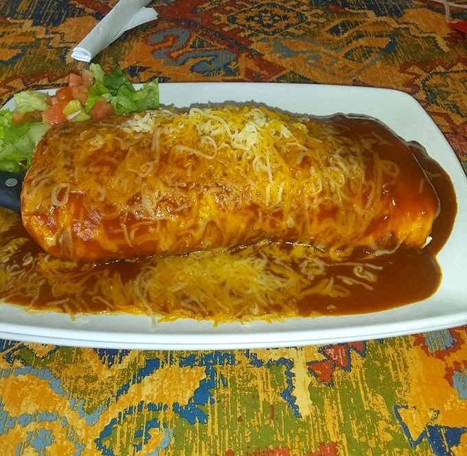 Behold the legendary Burrito Gigante in all its cheese-smothered glory – a monument to the art of excess done right.
