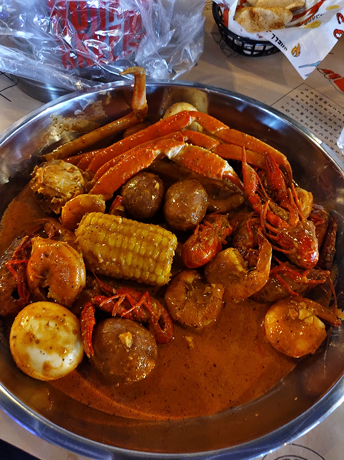 Behold the main event: a glorious seafood boil where crab legs, crawfish, shrimp, and corn commingle in spicy harmony.