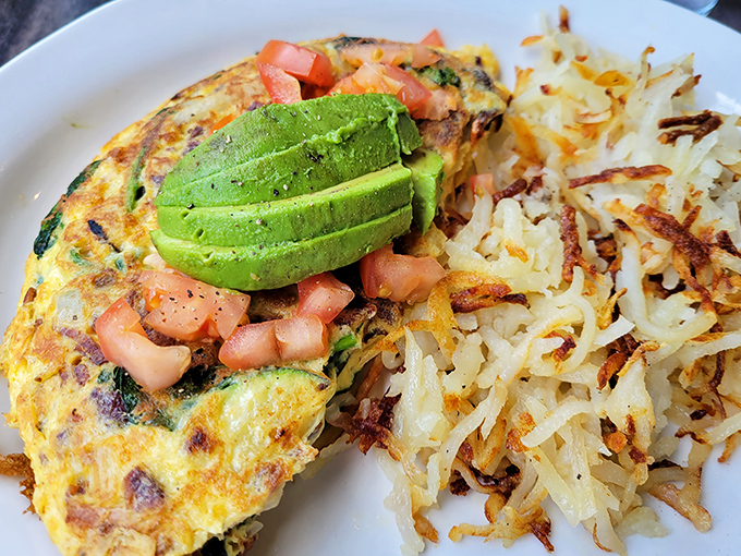 This California omelet doesn't just talk the talk&mdash;perfectly cooked eggs cradle fresh avocado and diced tomatoes alongside hash browns that achieve the golden-brown perfection we all attempt at home.