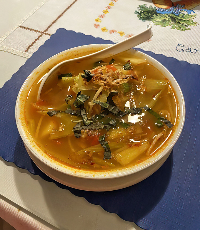 The Canh Chua sweet and sour soup that started it all, looking like liquid sunshine with a personality disorder.
