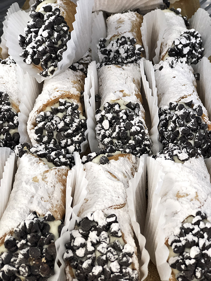 These cannolis aren't just desserts; they're edible treasure chests. Crisp shells guarding creamy riches topped with chocolate chips&mdash;resistance is futile.
