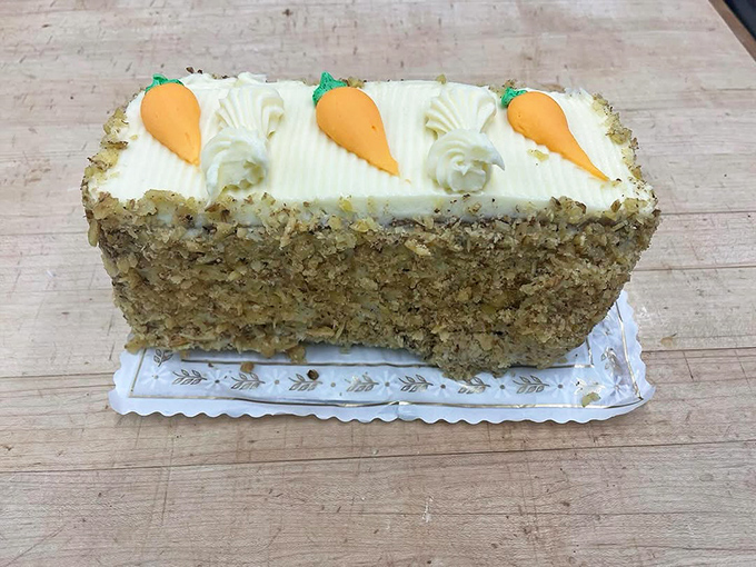 Behold the carrot cake that launched a thousand cravings! Cream cheese frosting piped with precision, topped with adorable carrot decorations.