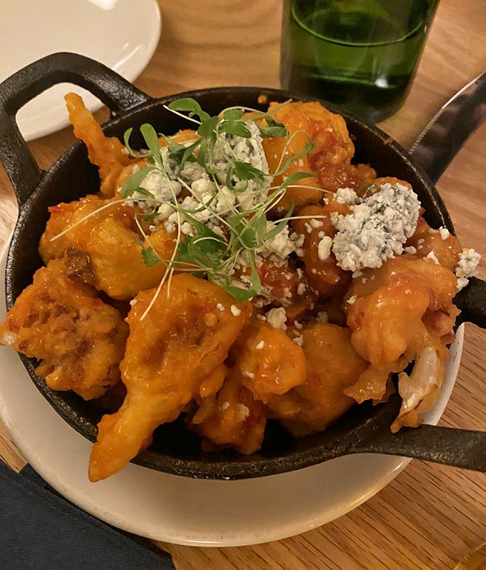Buffalo cauliflower that makes you question everything you thought you knew about vegetables&mdash;crispy, saucy, and topped with blue cheese crumbles.