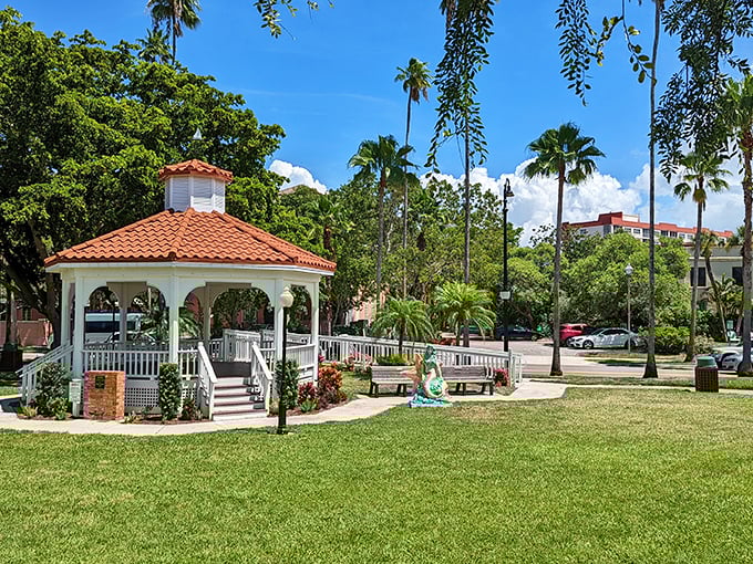 Centennial Park's gazebo stands as Venice's community living room, where locals gather under terra cotta tiles and Florida sunshine.