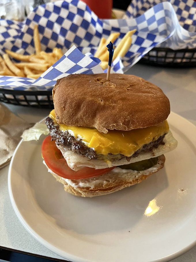 This isn't just a cheeseburger; it's edible nostalgia stacked between two buns, where melty cheese meets juicy beef in perfect harmony.
