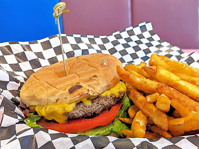 This isn't just a cheeseburger; it's edible architecture &ndash; a hand-formed patty wearing its cheese like a melted crown, served with fries that demand to be dunked.