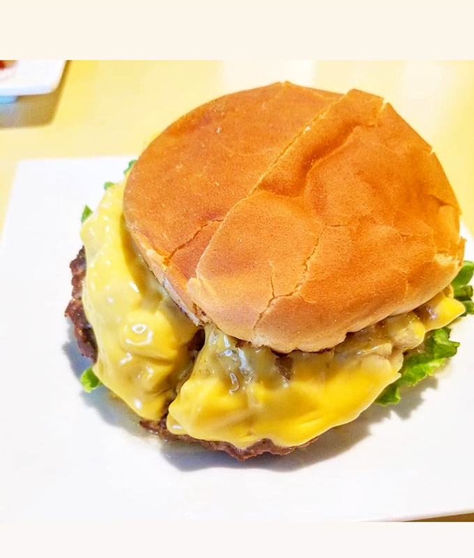Not just a cheeseburger, but a golden monument to dairy devotion where cheese cascades over beef like a Wisconsin waterfall.