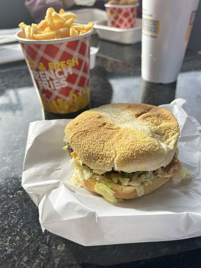 This isn't just a burger—it's edible architecture. Notice how the bun cradles the fixings with the structural integrity of a Frank Lloyd Wright design.