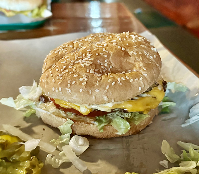 The star of the show: a perfectly constructed cheeseburger on a sesame seed bun. No foam, no deconstruction, no nonsense&mdash;just pure American happiness.