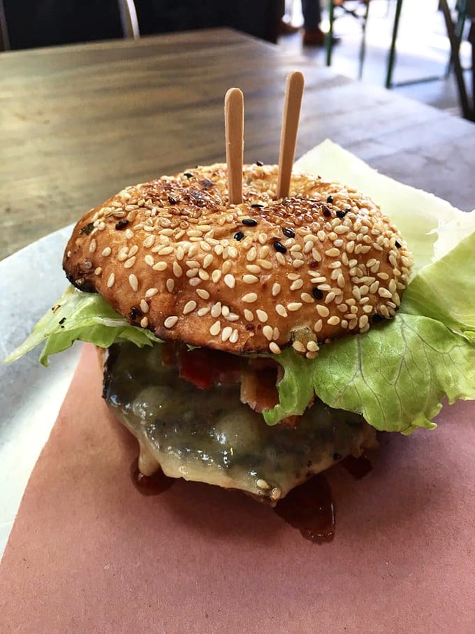 The "Best Damn Grass Fed Cheeseburger" isn't just a name &ndash; it's a sesame-studded promise delivered with melty cheese and perfect proportions.
