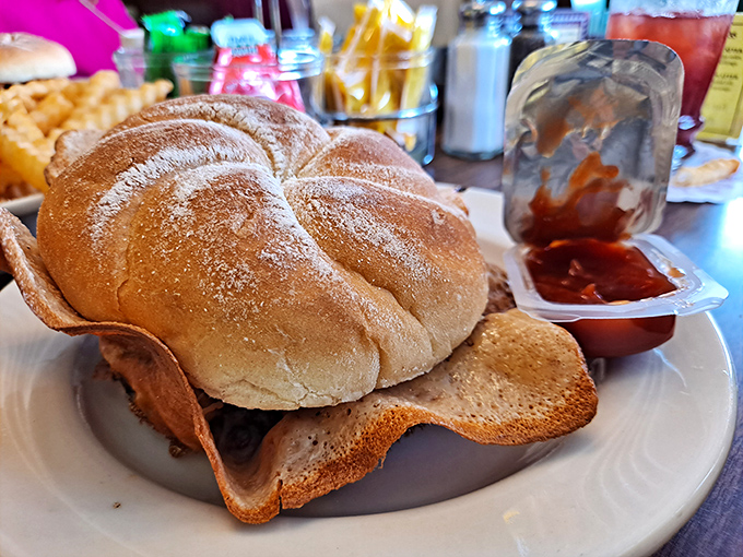 Not just a burger, but an architectural marvel. Those crispy cheese wings aren't an accident&mdash;they're the deliberate signature that keeps cars in the parking lot.