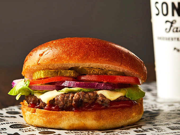 This isn't just a burger&mdash;it's edible architecture. The glistening cheese melts into beef while fresh veggies add crunch and color.