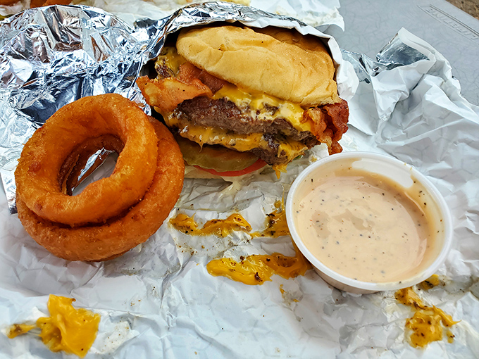 Behold the bacon cheeseburger in its natural habitat&mdash;wrapped in foil, accompanied by a golden onion ring, and destined for immediate consumption.