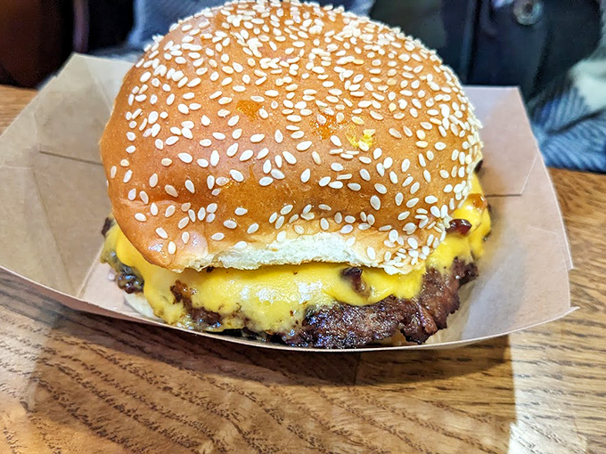 This isn't just a cheeseburger; it's a heavyweight champion on a sesame seed throne. The melted cheese cascades down like a victory robe.