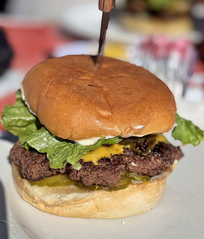 Not all heroes wear capes, but all legendary burgers wear perfectly melted cheese, crisp lettuce, and a bun that somehow contains this beautiful chaos.
