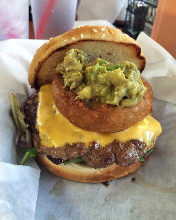 Behold the engineering marvel: melted cheese cascading over beef with an onion ring crown for good measure.