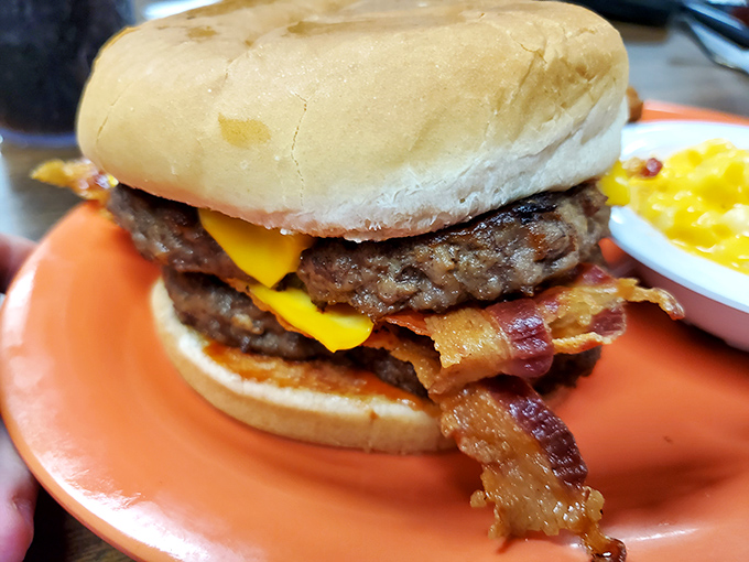 Behold the burger that launched a thousand road trips &ndash; layers of beef, cheese, and bacon stacked with architectural precision that would make Frank Lloyd Wright jealous.