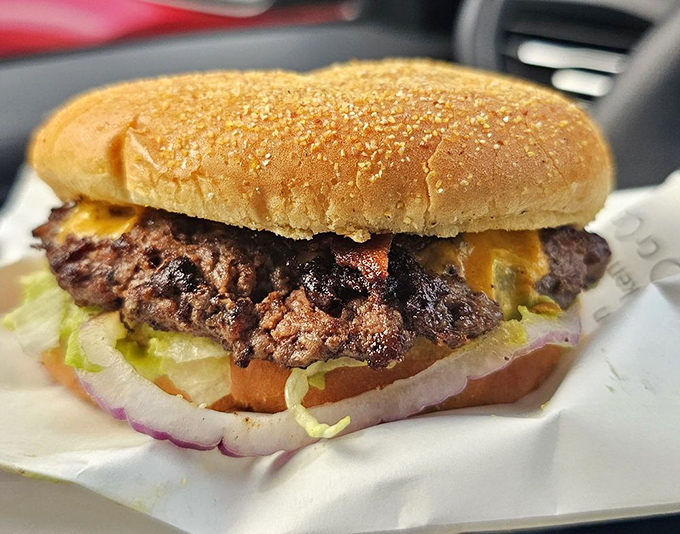 Behold the star of the show&mdash;a perfectly grilled patty nestled in a golden bun with melty cheese cascading down the sides. Poetry in burger form.