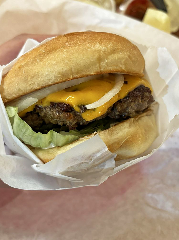 Behold, the classic cheeseburger in its natural habitat&mdash;perfectly melted American cheese embracing a hand-formed patty like they were made for each other.