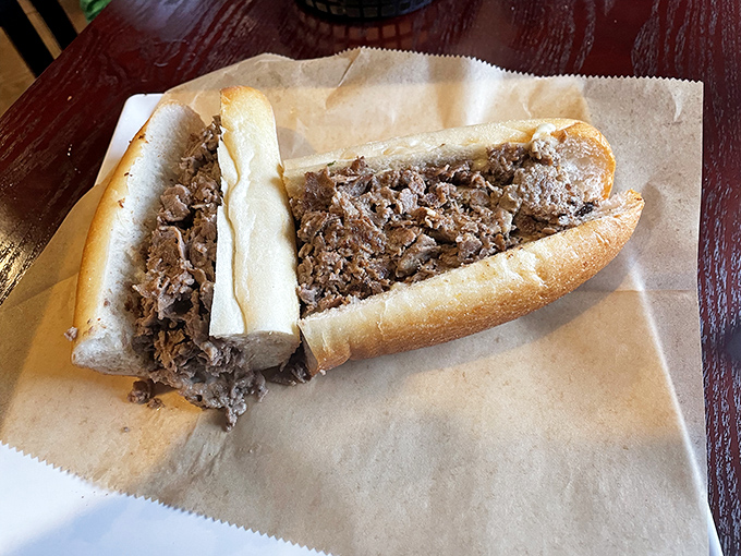 Behold the star of the show—thinly sliced beef nestled in a perfect roll. This cheesesteak doesn't need neon lights to announce its greatness.