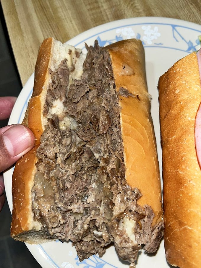 Behold the star of the show: thinly sliced ribeye piled generously on a perfect roll. This isn't just a cheesesteak; it's edible architecture.