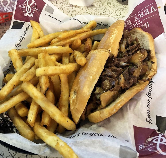 Not all heroes wear capes. Some come nestled in a perfect roll with golden fries standing guard alongside. This cheesesteak means business.