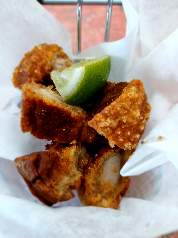Golden-brown chicharrones that crackle like nature's potato chips, with a squeeze of lime that cuts through the richness like a tropical breeze.