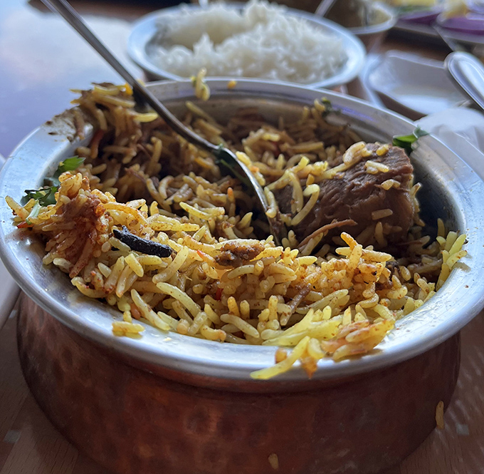 Behold the star attraction: chicken biryani that makes each grain of rice a character in a delicious drama of spices and tenderness.