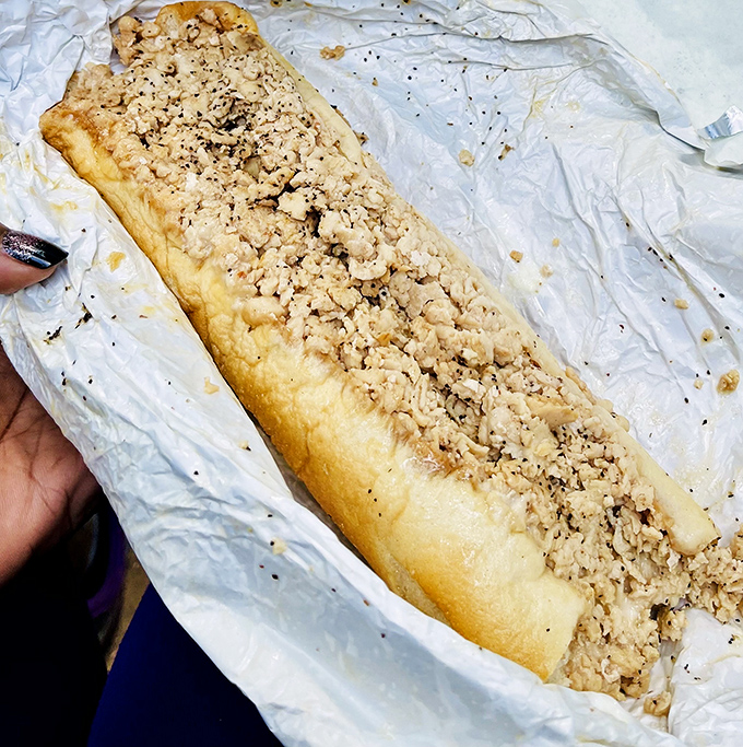 Behold the chicken cheesesteak in its natural habitat &ndash; wrapped in paper, perfectly chopped, and ready to make you question why you've eaten anything else.