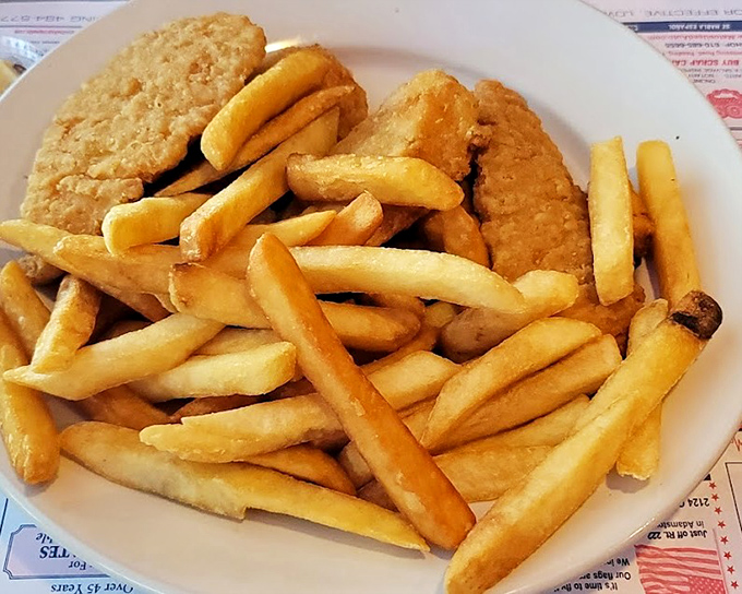 Golden-brown chicken fingers that could make a food critic weep, served with a mountain of fries that demands to be devoured.