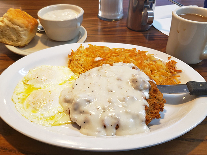 Behold the star attraction: chicken fried steak swimming in peppery gravy with eggs and hash browns—a plate that's worth every mile of the journey.