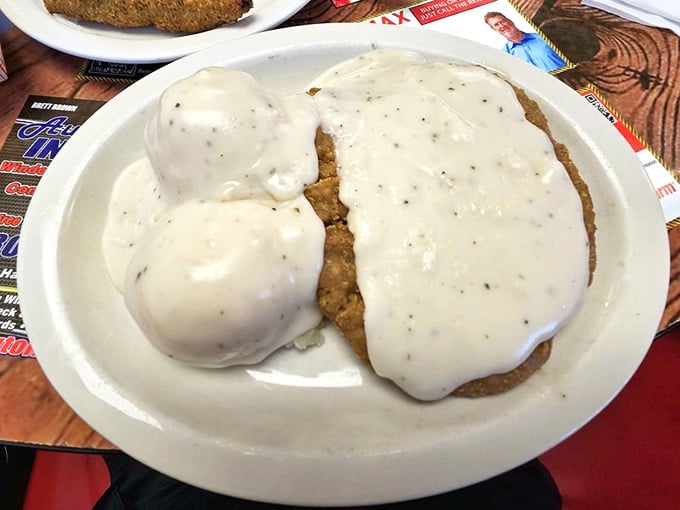 Behold the crown jewel: chicken fried steak swimming in pepper-flecked gravy alongside pillowy mashed potatoes. This isn't just dinner&mdash;it's an Oklahoma heirloom on a plate.