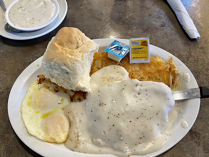 Behold the legendary chicken fried steak in its natural habitat&mdash;swimming in peppery country gravy with eggs and hash browns standing guard.