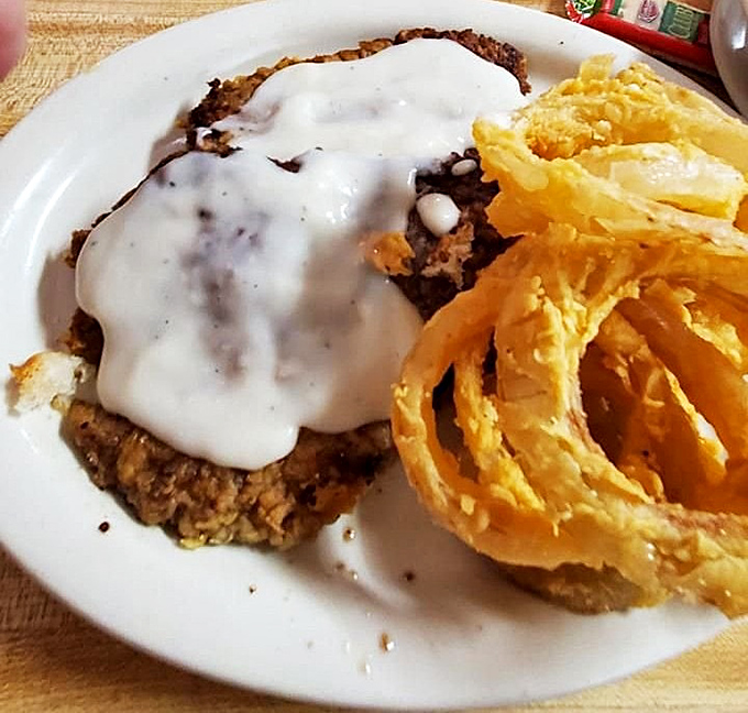 Behold the star attraction: a chicken fried steak that's achieved the perfect golden crust-to-tender meat ratio, smothered in gravy that should be declared a state treasure.