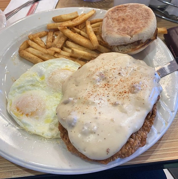 Country fried steak smothered in creamy gravy&mdash;proof that some mornings require serious sustenance and a nap scheduled for later.