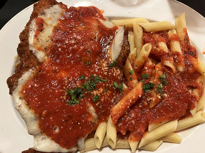 Behold the star attraction: chicken parmesan that makes you want to write sonnets, with pasta that's the perfect supporting actor.