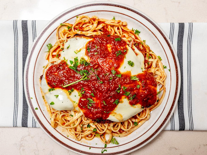 Behold the star attraction: chicken parmigiana that makes other Italian restaurants nervously check their recipes. That cheese pull deserves its own ZIP code.